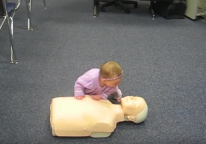Baby Demonstrates CPR On Dummy